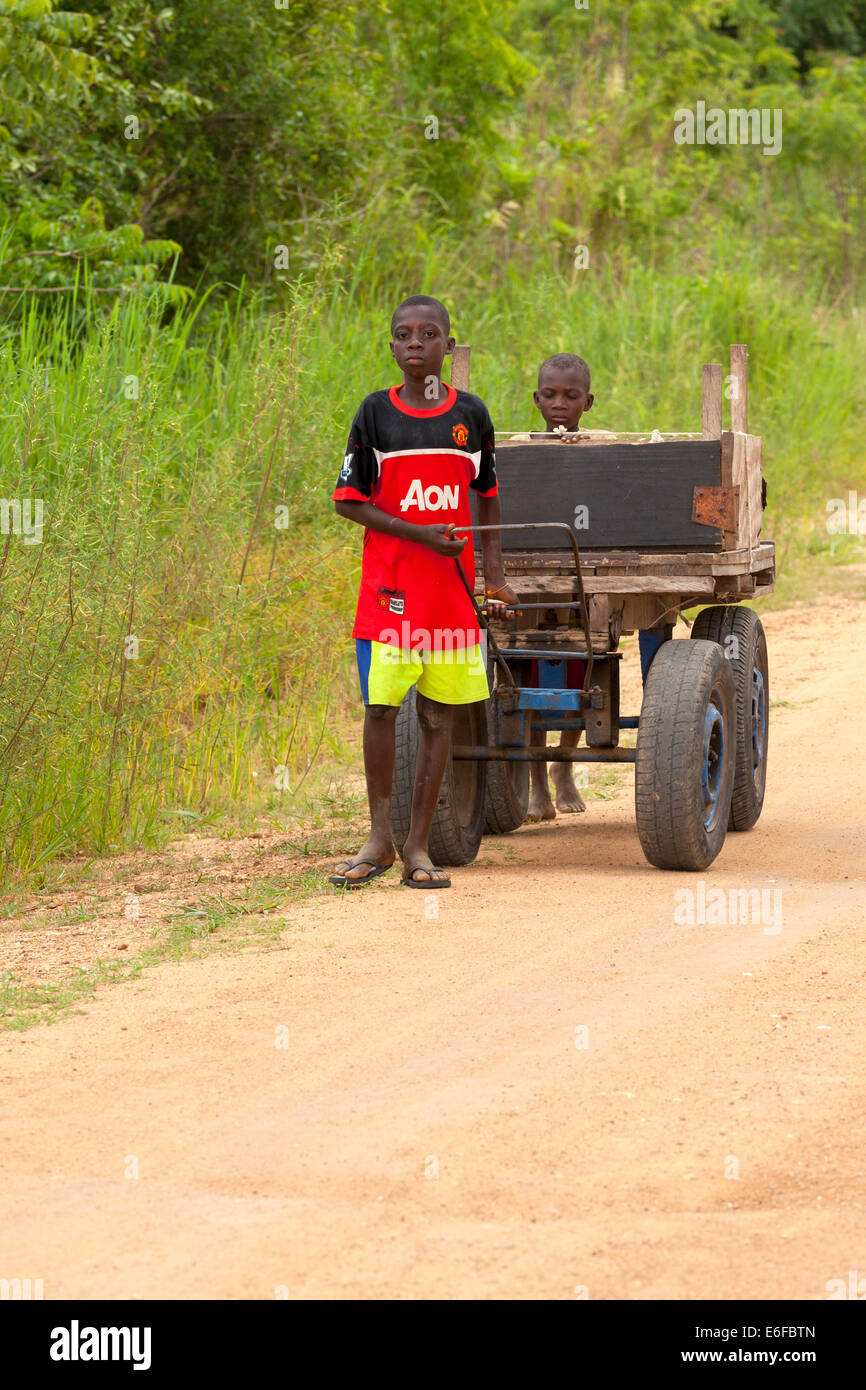 Children pulling cart on rural road, Greater Accra, Ghana, Africa Stock ...
