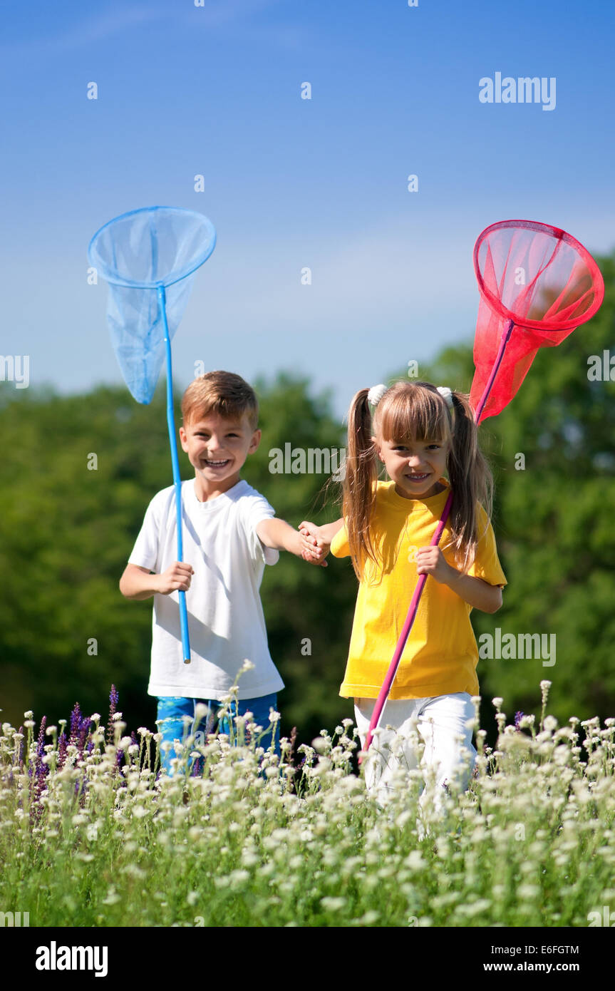 Happy children on meadow Stock Photo - Alamy
