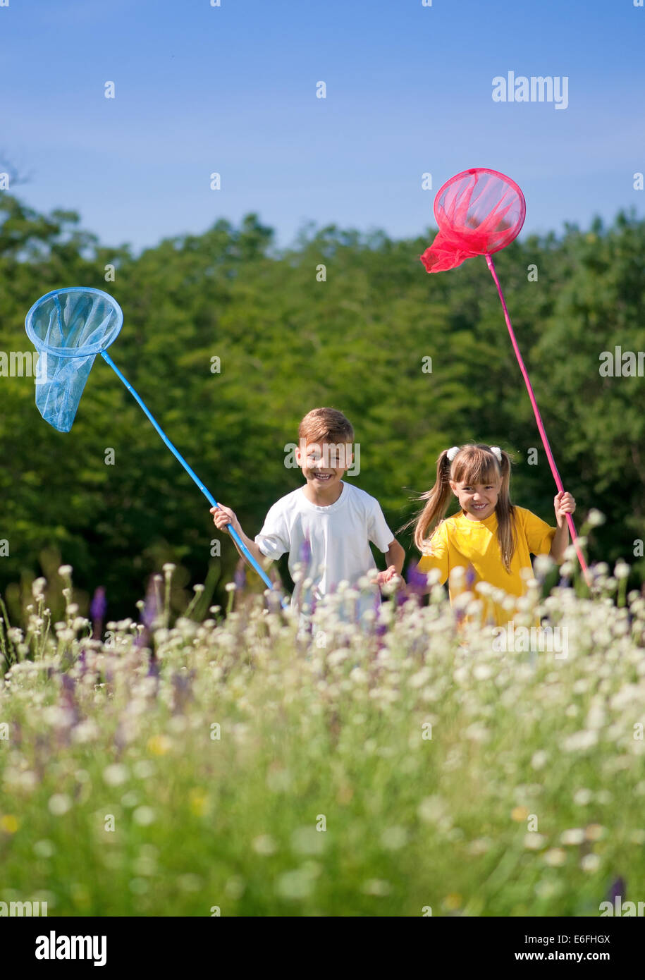 Happy children on meadow Stock Photo - Alamy