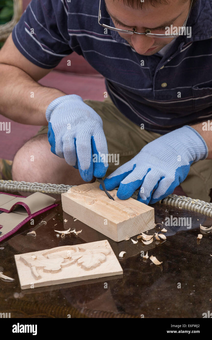 Seated man carving hi-res stock photography and images - Alamy