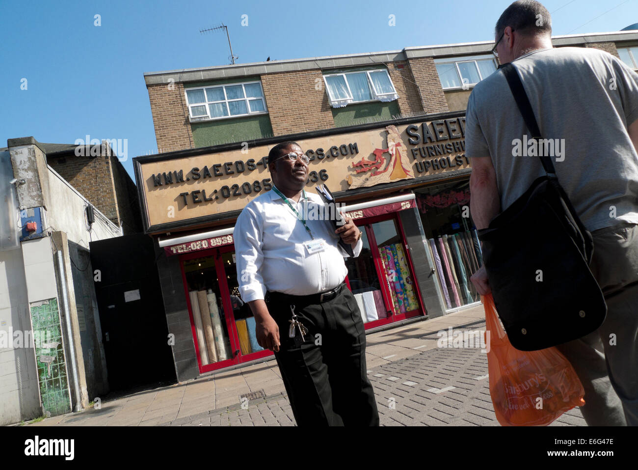 Man speaking to Walthamstow Market Inspector on Walthamstow High Street ...