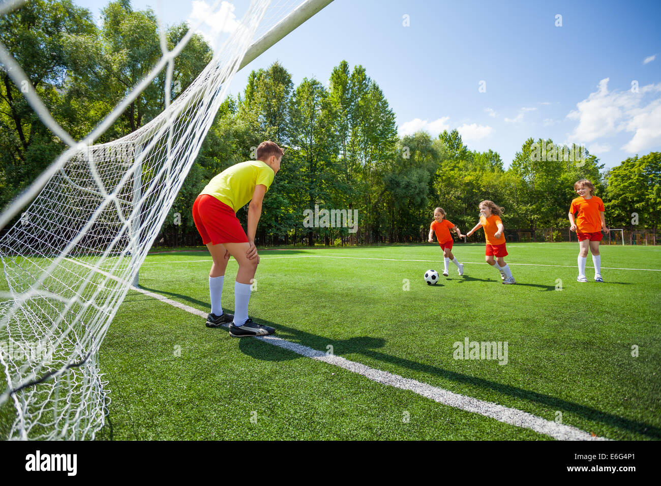 Children play football together, goalkeeper wait Stock Photo - Alamy