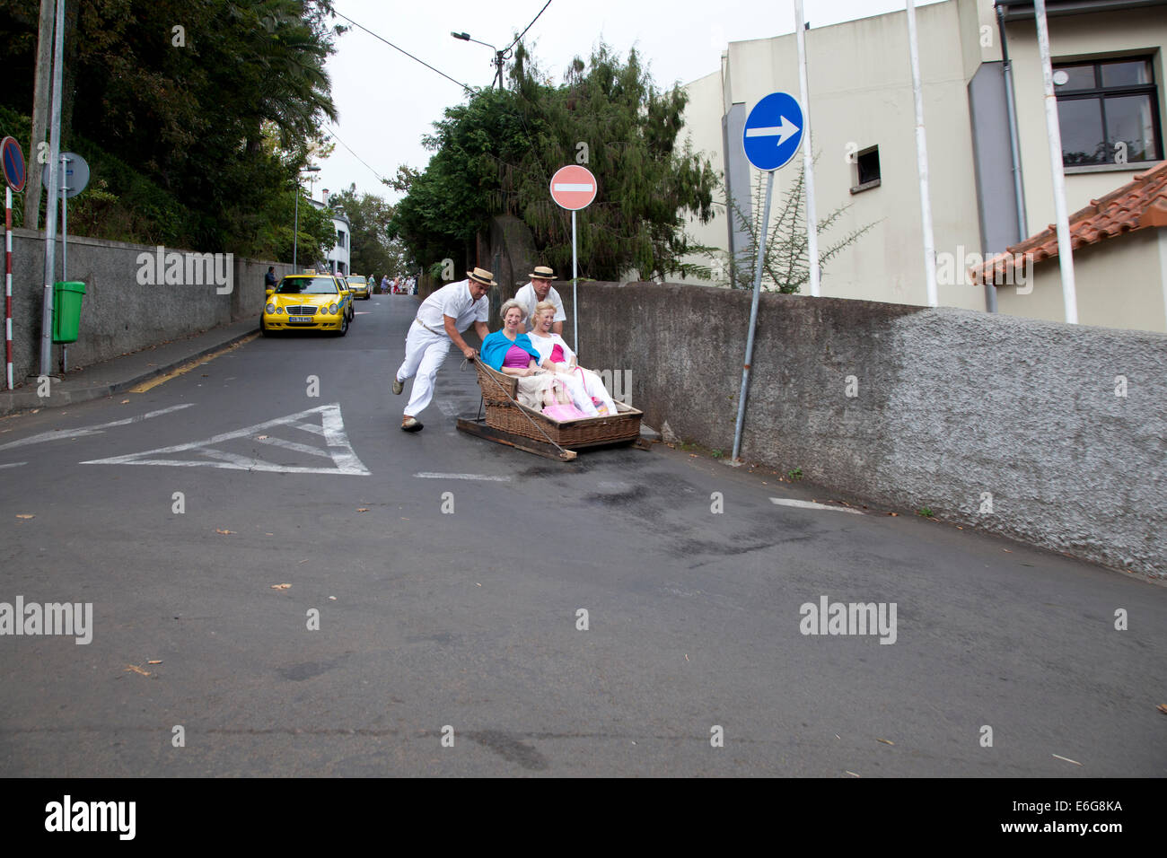 People riding sled in madeira Stock Photo - Alamy