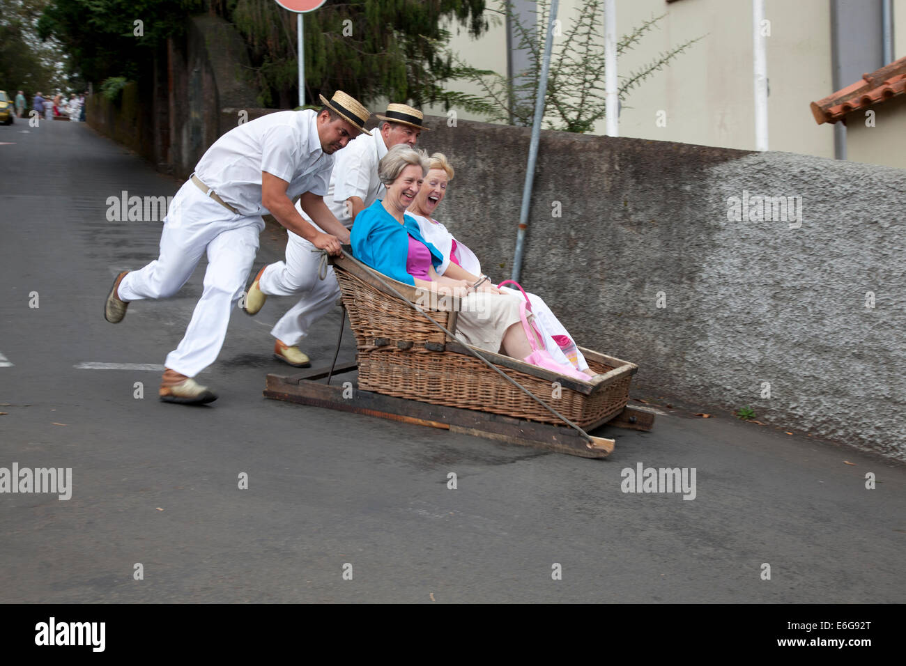 People riding sled in madeira Stock Photo - Alamy