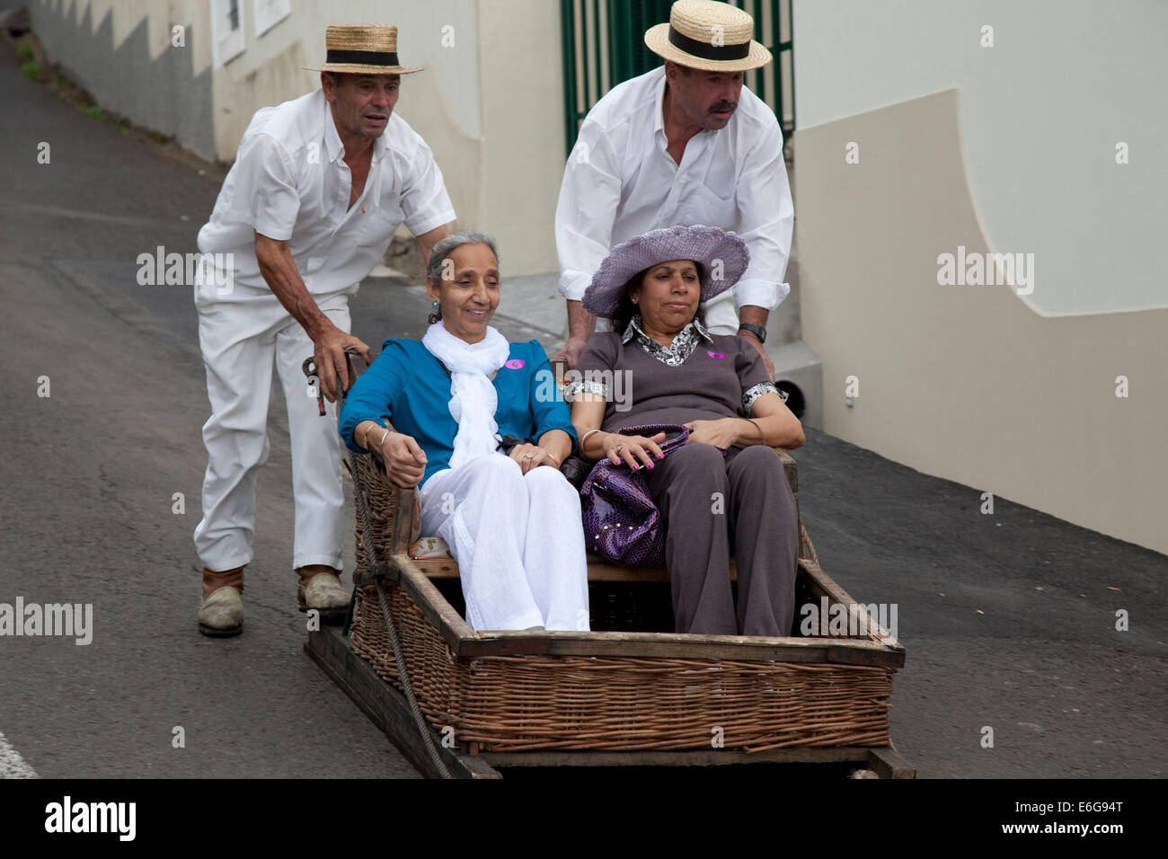 People riding sled in madeira Stock Photo - Alamy