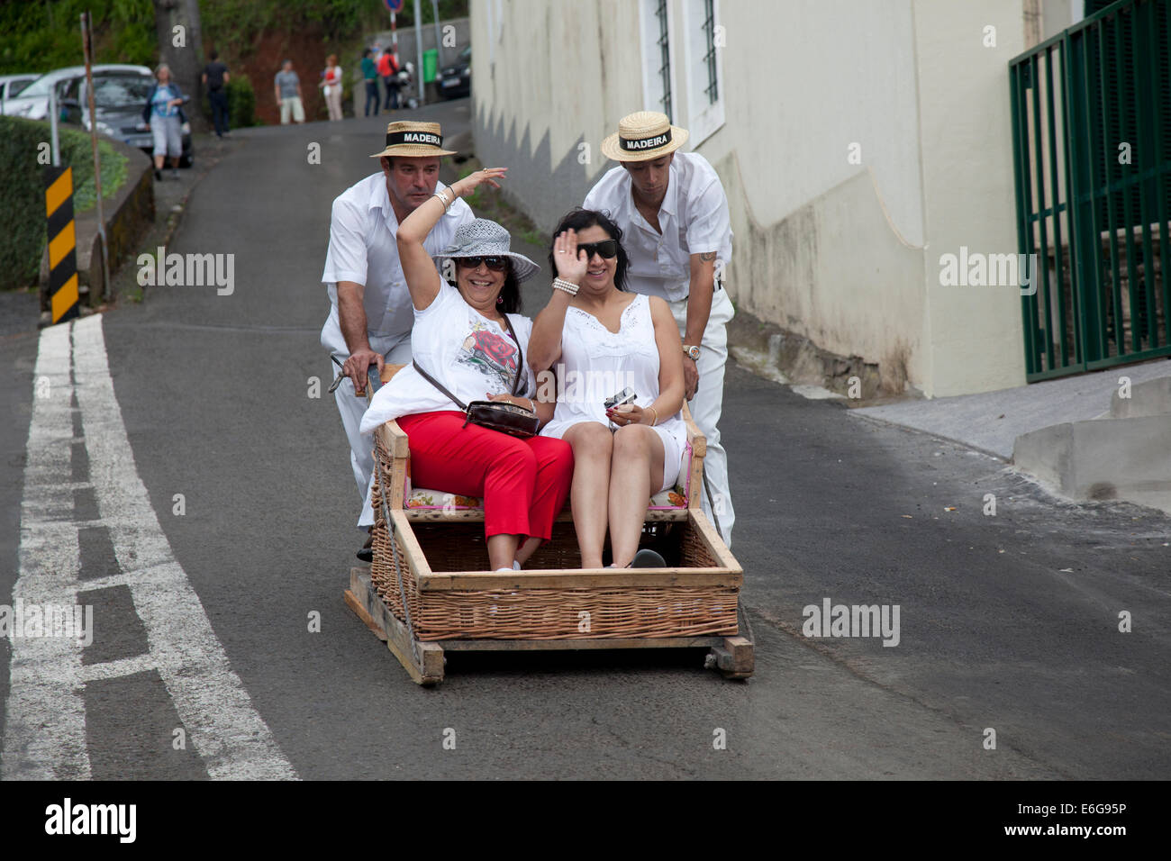People riding sled in madeira Stock Photo - Alamy