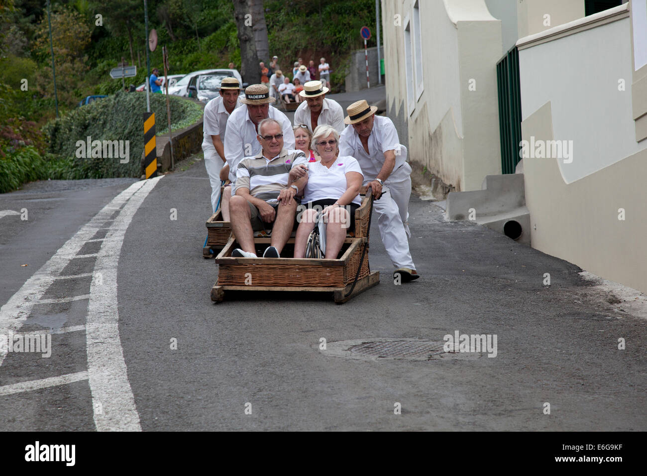 People riding sled in madeira Stock Photo - Alamy