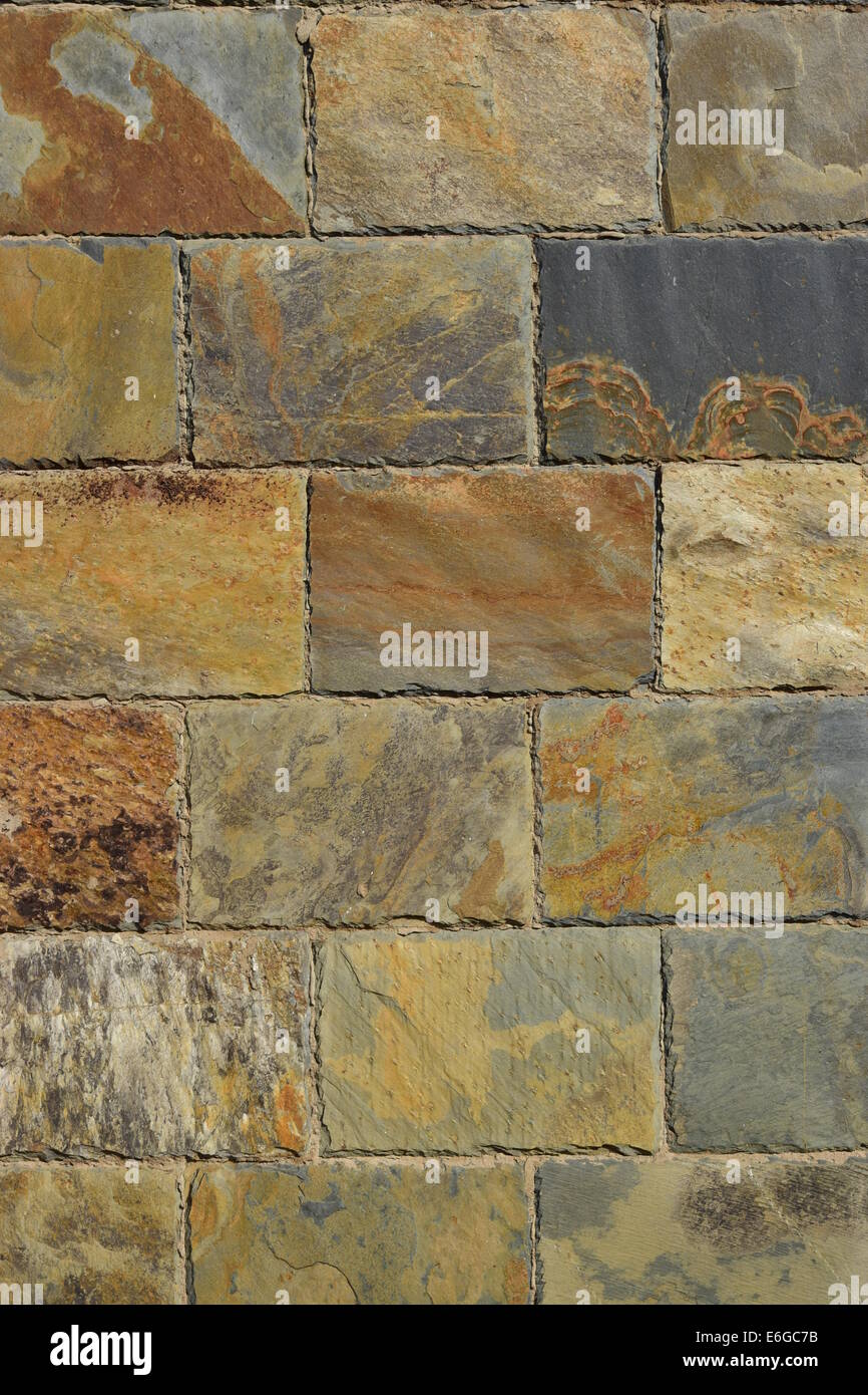 Wall made of rough colorful stone blocks - to be used as background ...
