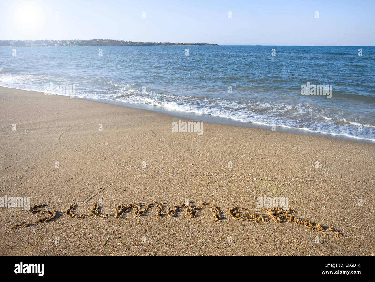 "Summer" written in the sand on the beach with blue waves in the ...