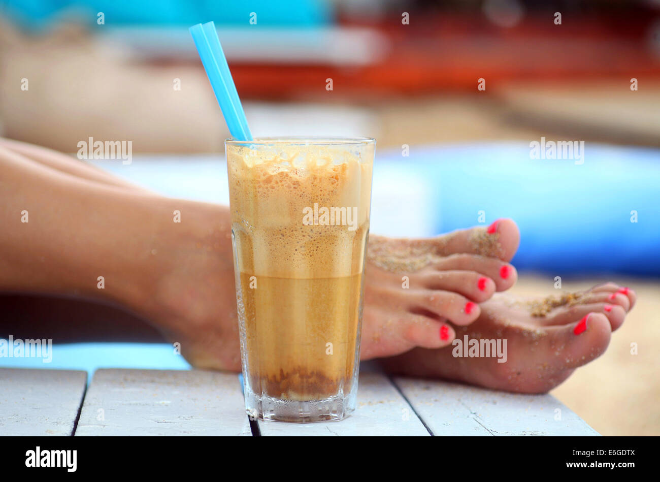 Iced coffee and feet in an exotic beach Stock Photo - Alamy