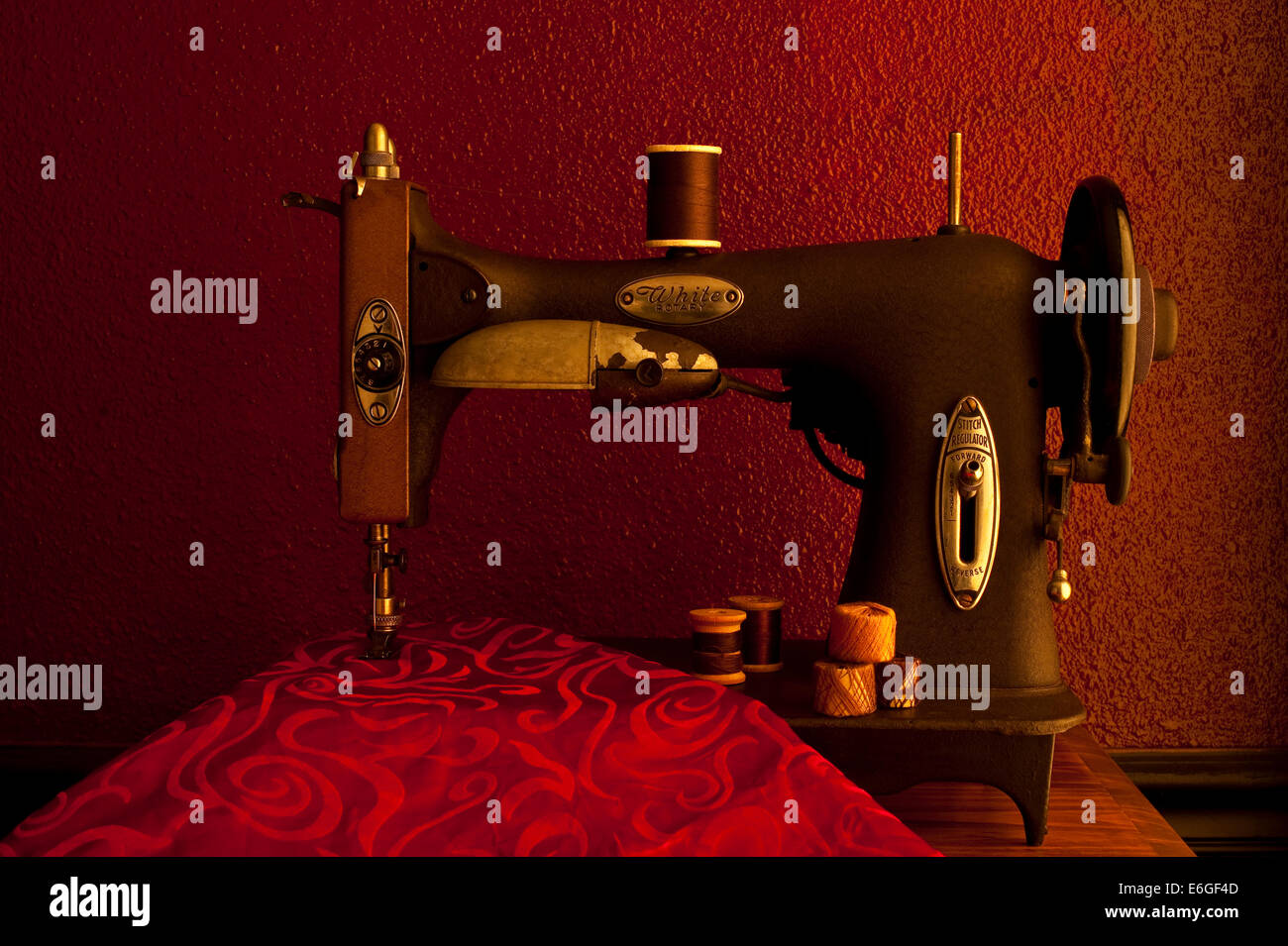 Antique sewing machine with fabric and thread spools Stock Photo - Alamy