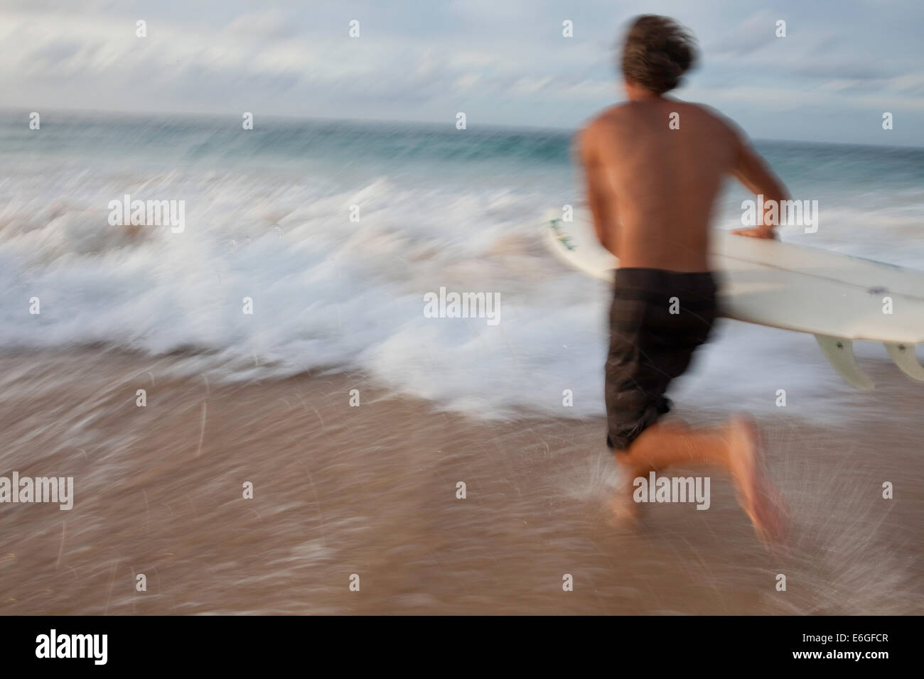 Surfer running water sandy beach hi-res stock photography and images ...