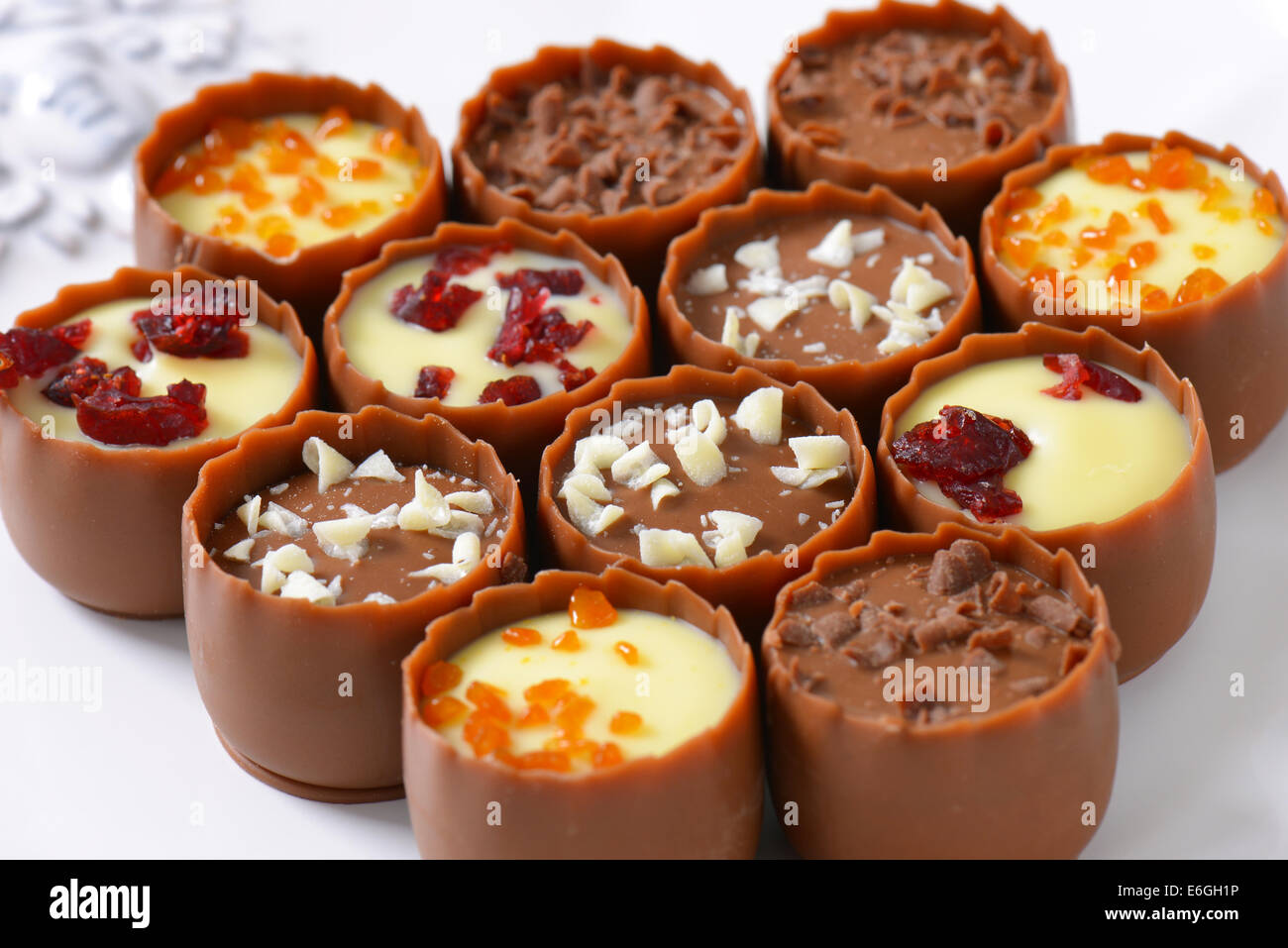 Delicate milk chocolate cups with liqueur and ganache centres Stock ...