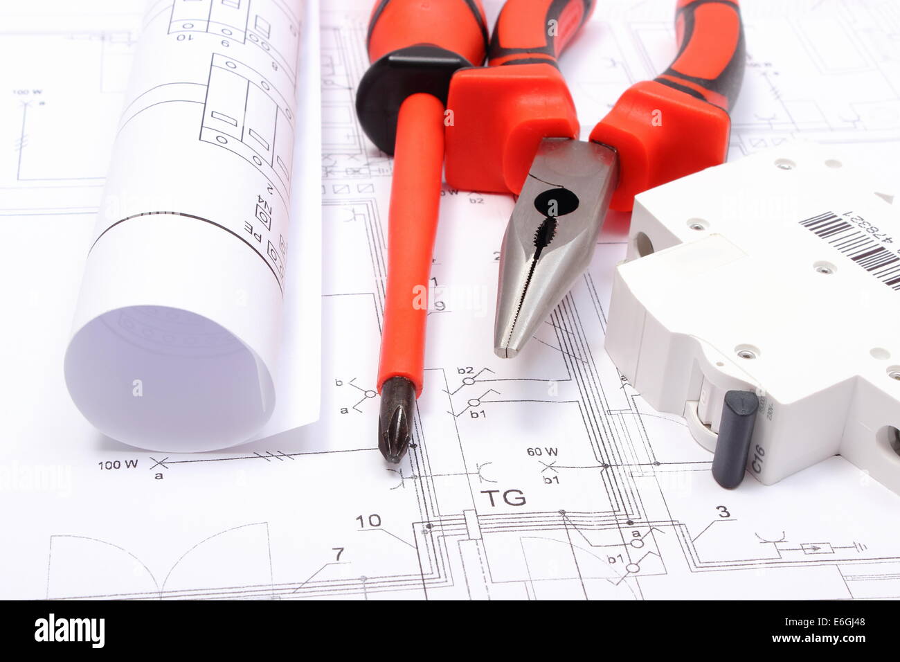 Rolled electrical diagrams, electric fuse and work tools lying on ...