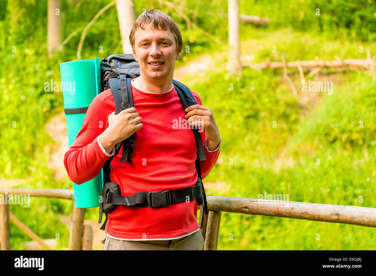 happy man with a backpack hiking in the summer forest Stock Photo - Alamy
