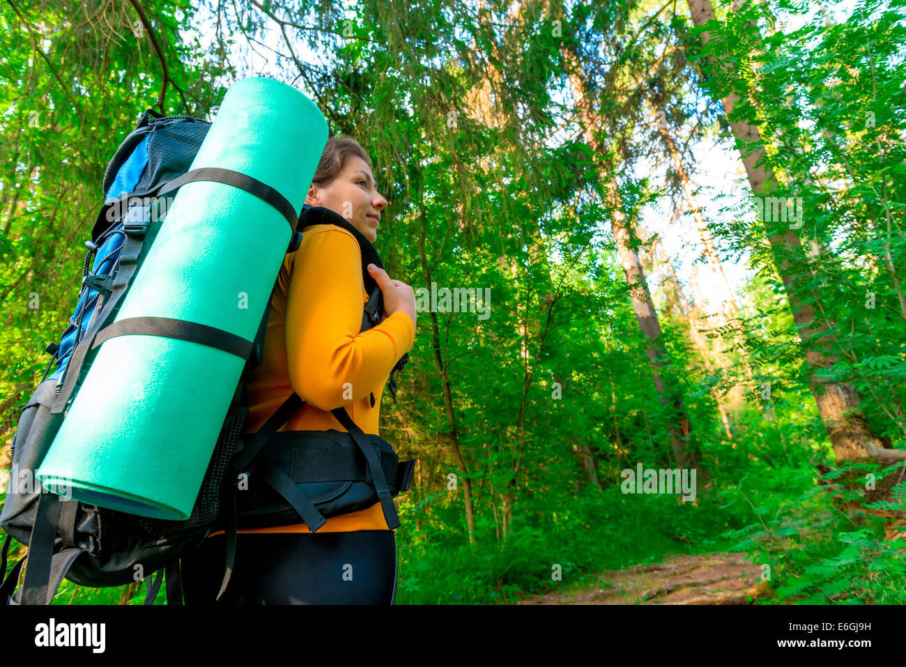 tourist with a backpack in the woods in search of the road Stock Photo ...