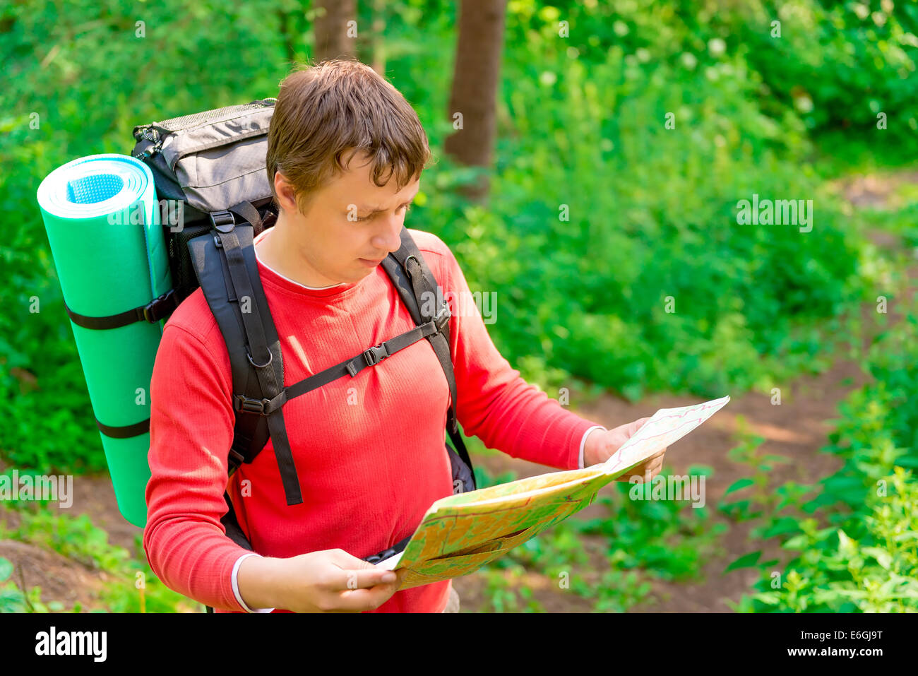 tourist is looking for its location on the map Stock Photo - Alamy