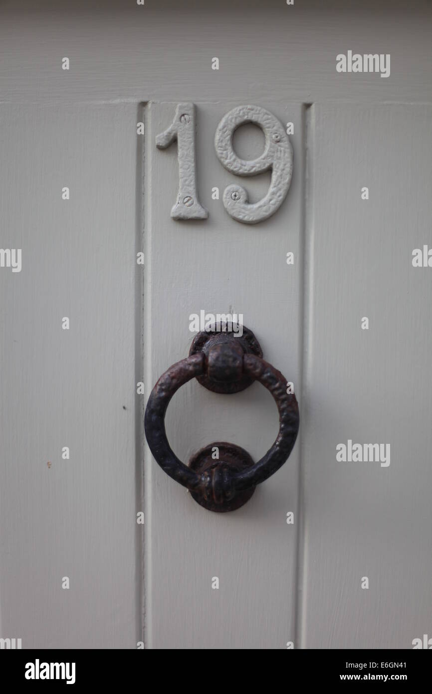 A number 19 on the front door of a Cornish cottage with contrasting ...