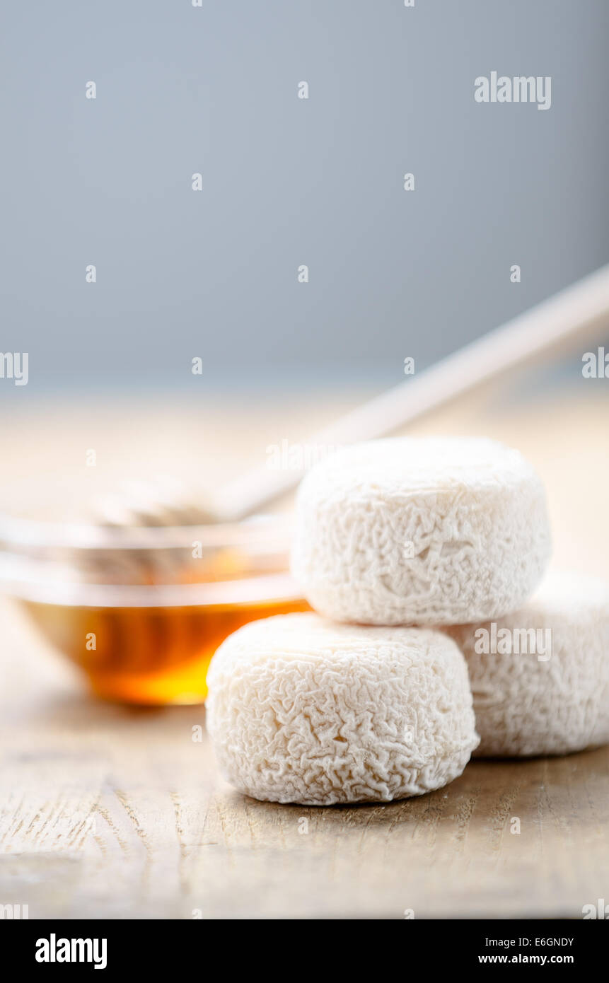 French fresh goat cheese called crottin de chavignol and honey Stock ...