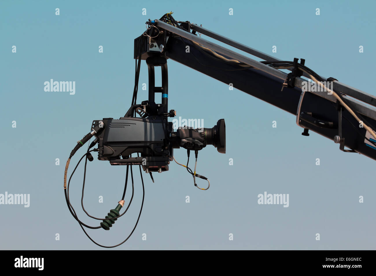 Broadcast camera on the crane against blue sky Stock Photo - Alamy