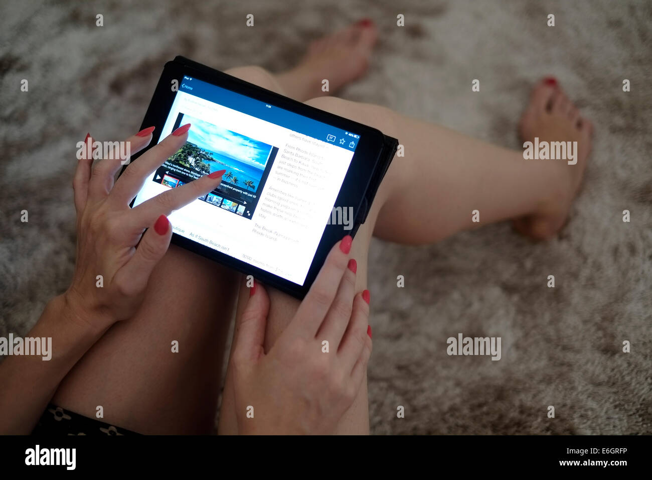 Young woman using an iPad tablet computer Stock Photo - Alamy