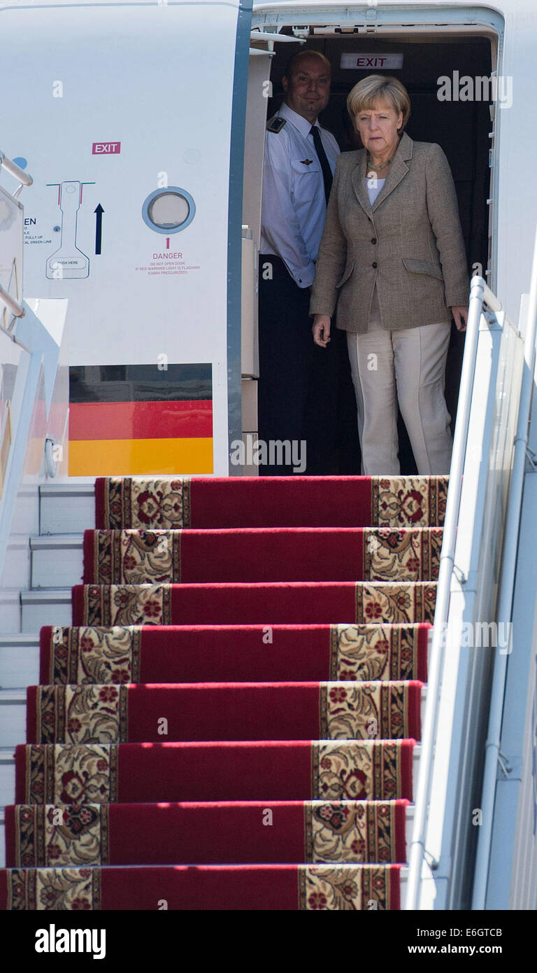 German Chancellor Angela Merkel prepares to exit an aircraft plane ...