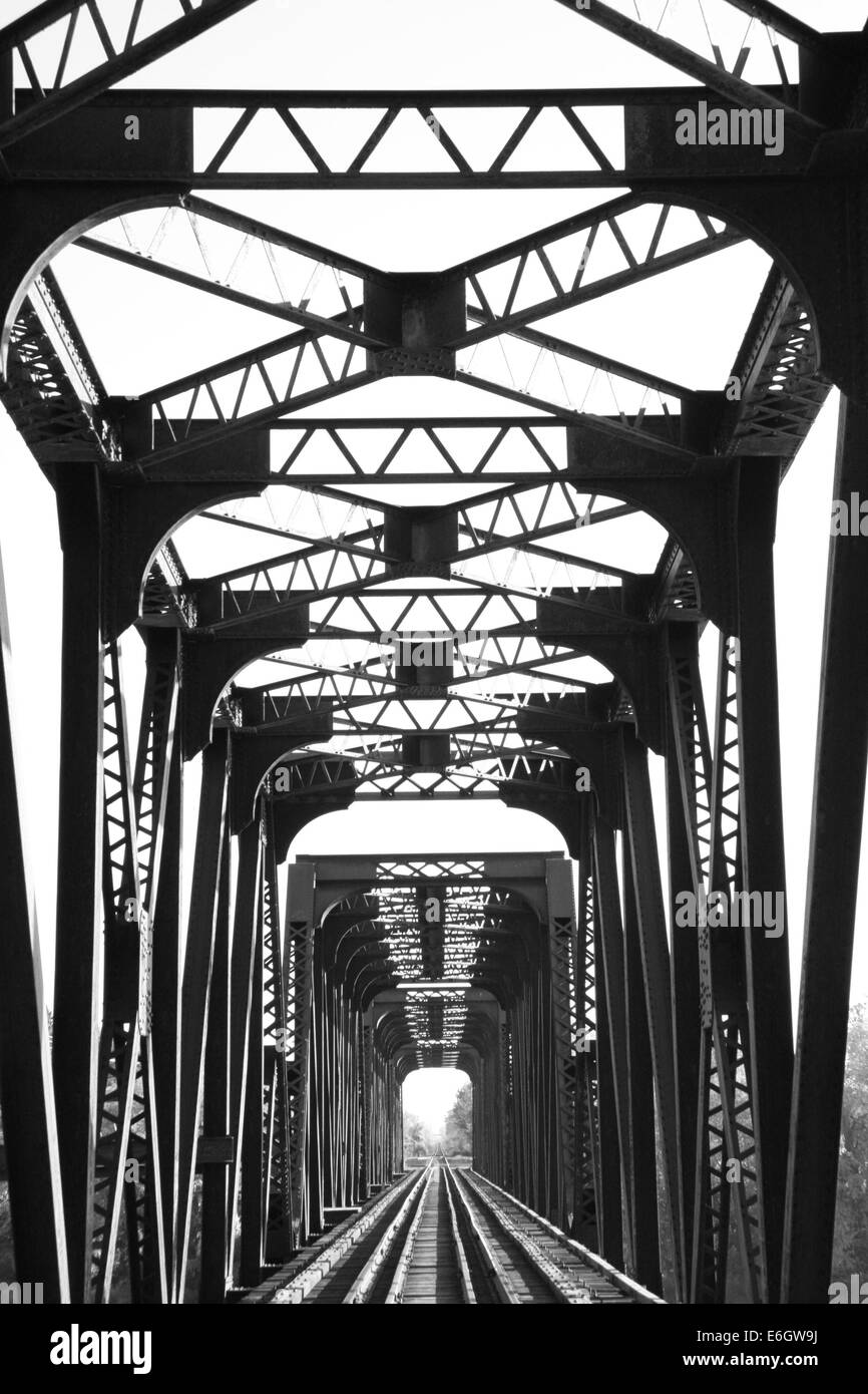 Train track bridge made of metal overpassing a river Stock Photo - Alamy