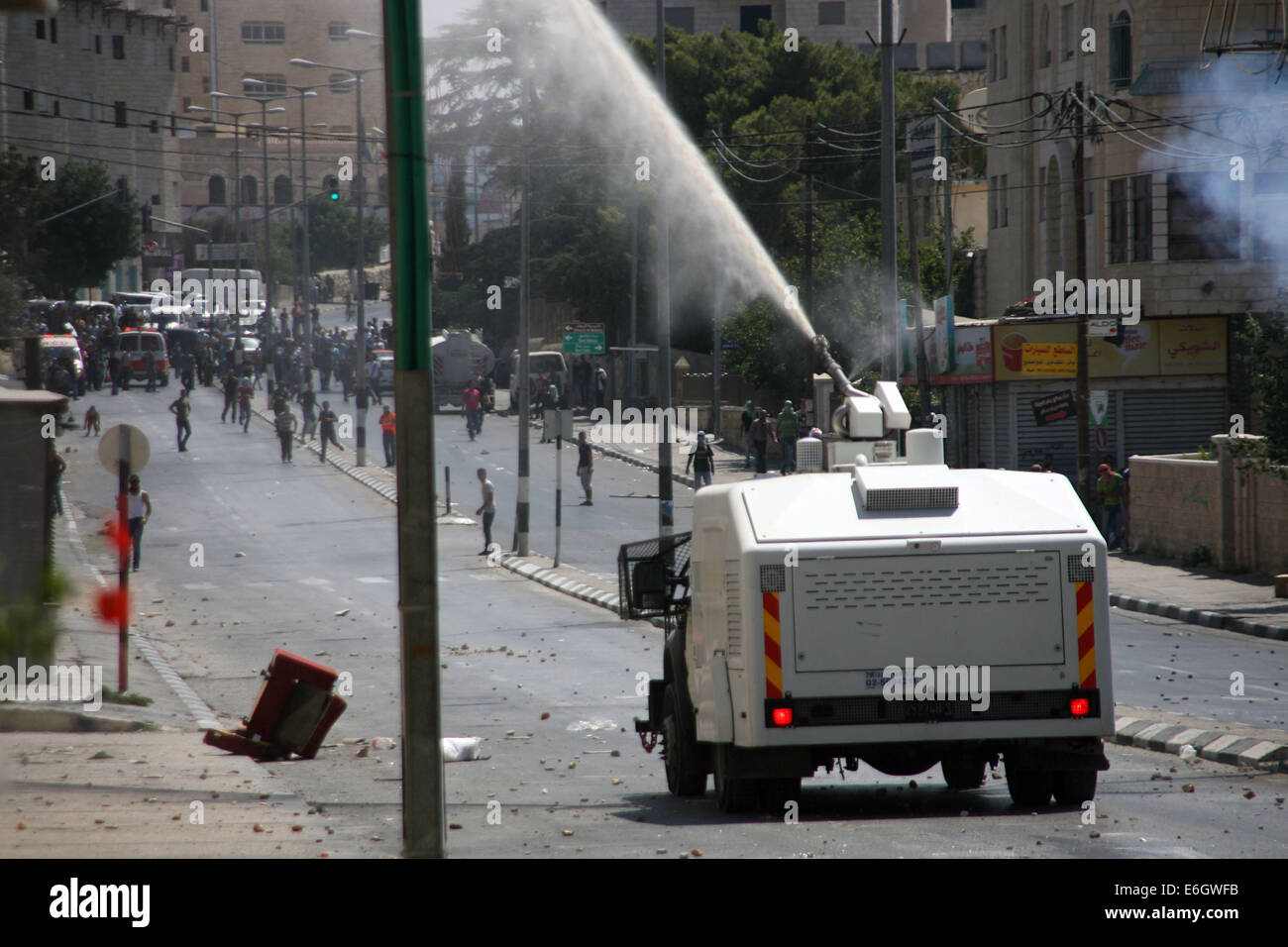 An Israeli army jeep sprays foul smelling water dubbed, "skunk water ...