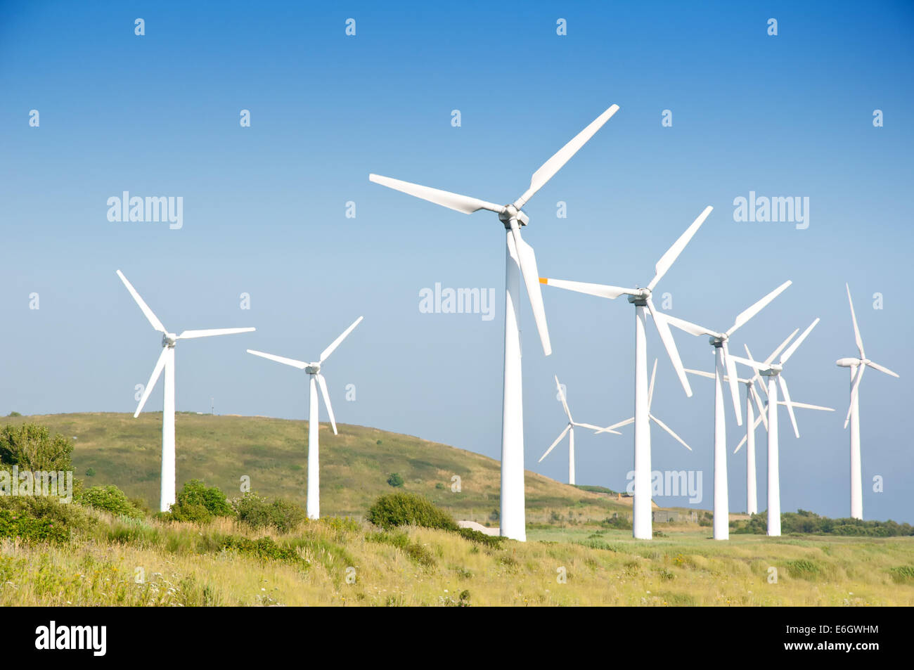 Wind turbines in lush green landscape Stock Photo - Alamy