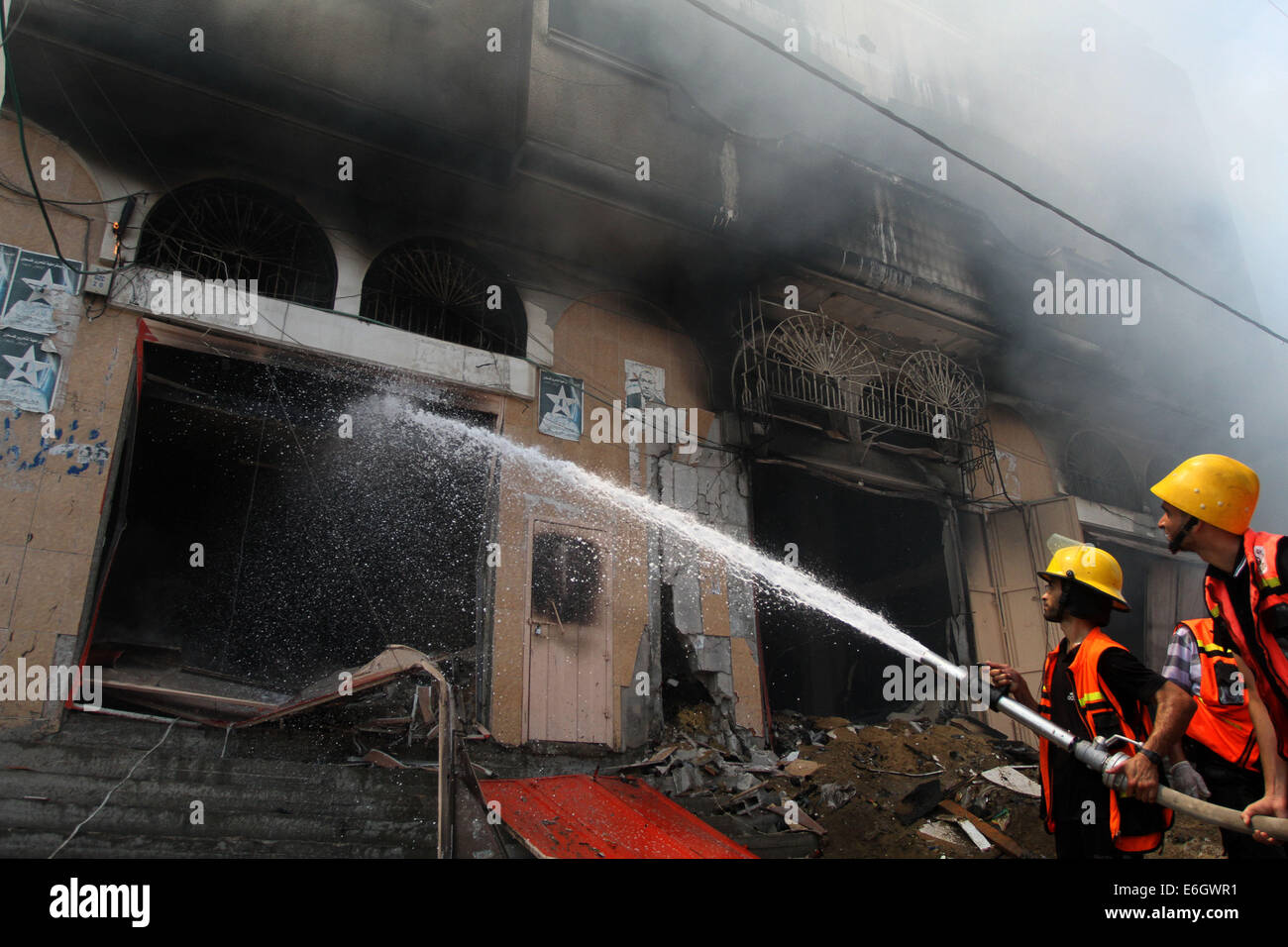 Gaza. 23rd Aug, 2014. Palestinian firefighters try to extinguish a fire ...