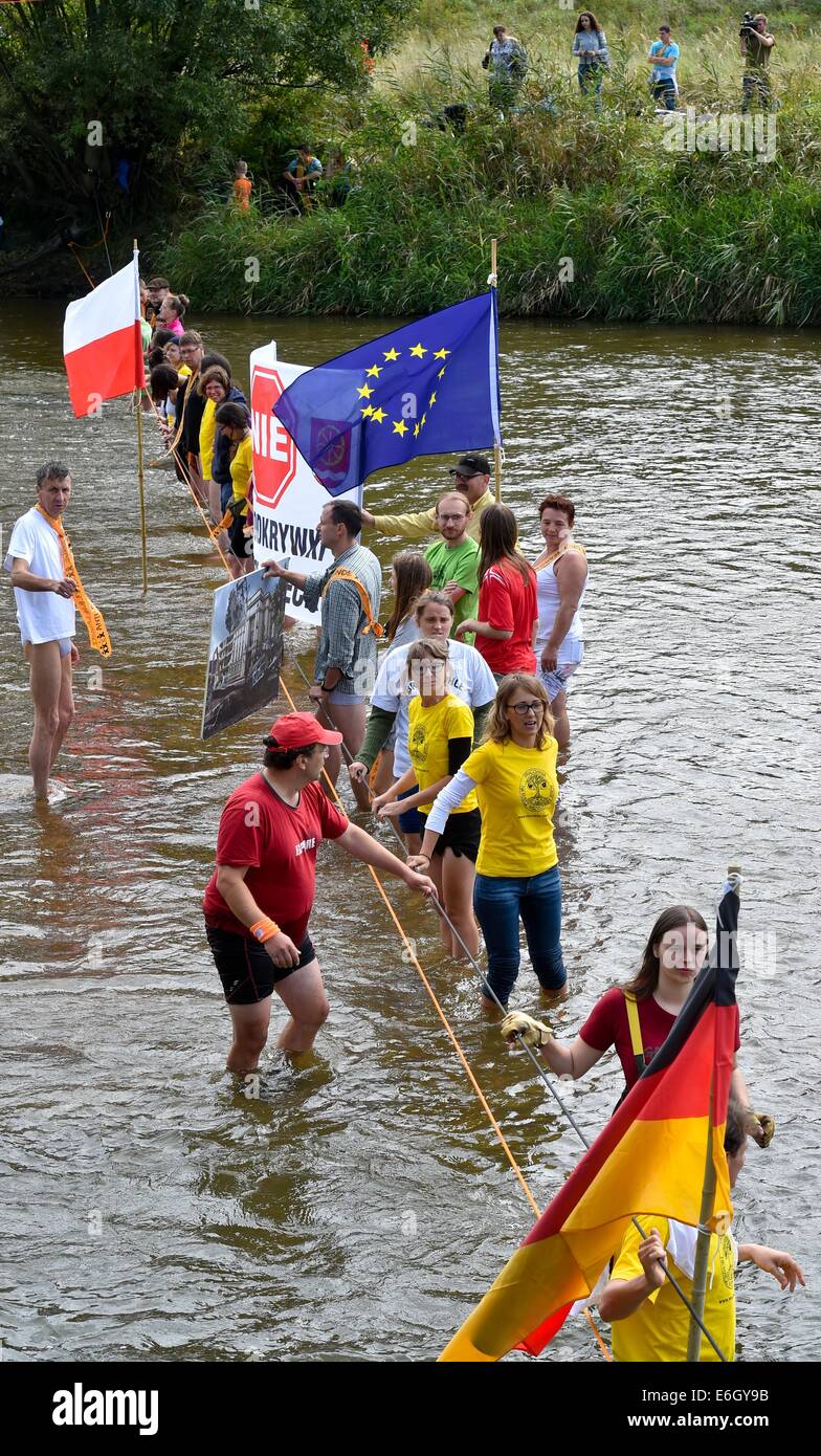 Coal opponents form a human chain across the Neisse River along the ...