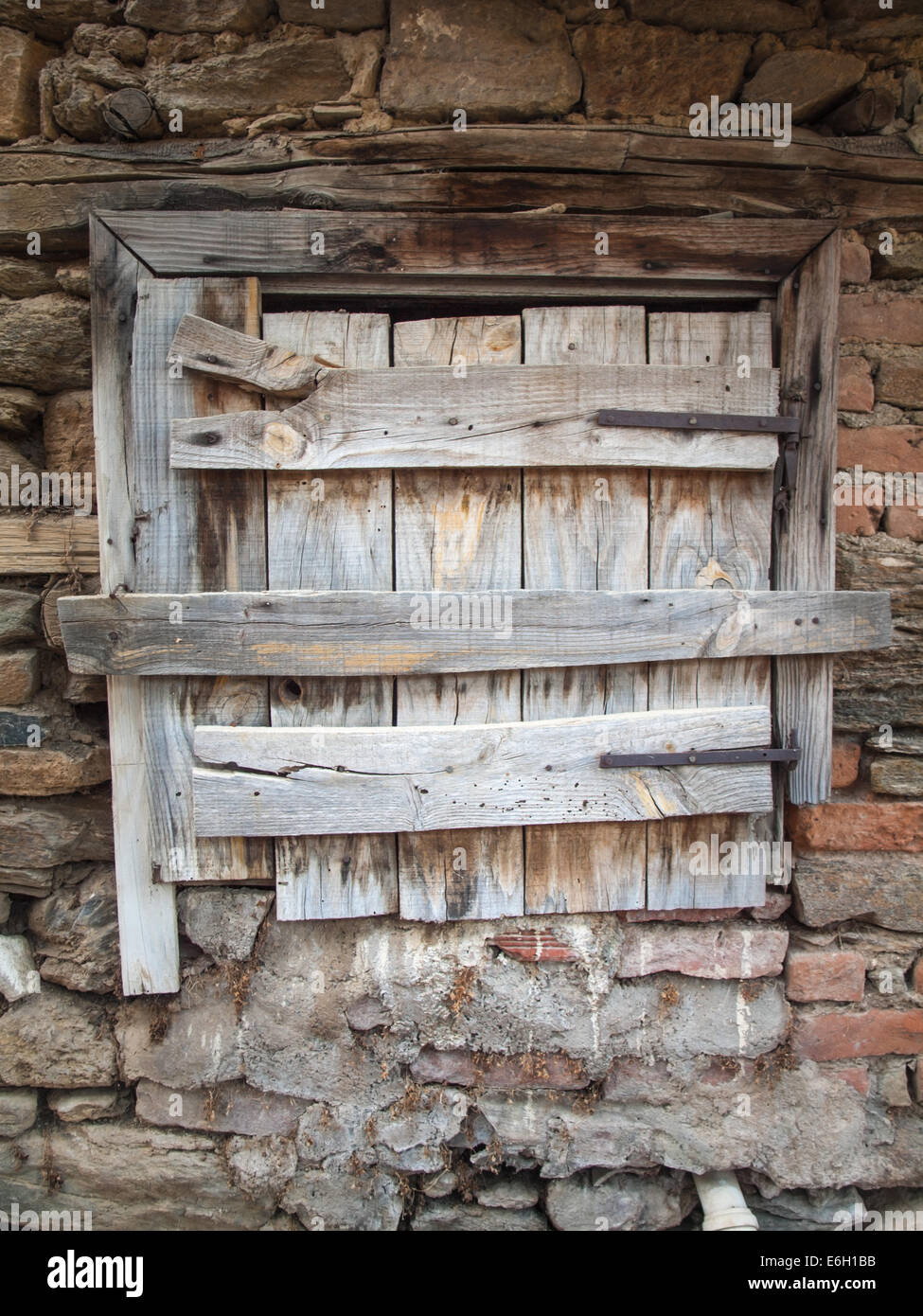 old rotten wooden hatch in a rustic brick wall Stock Photo - Alamy