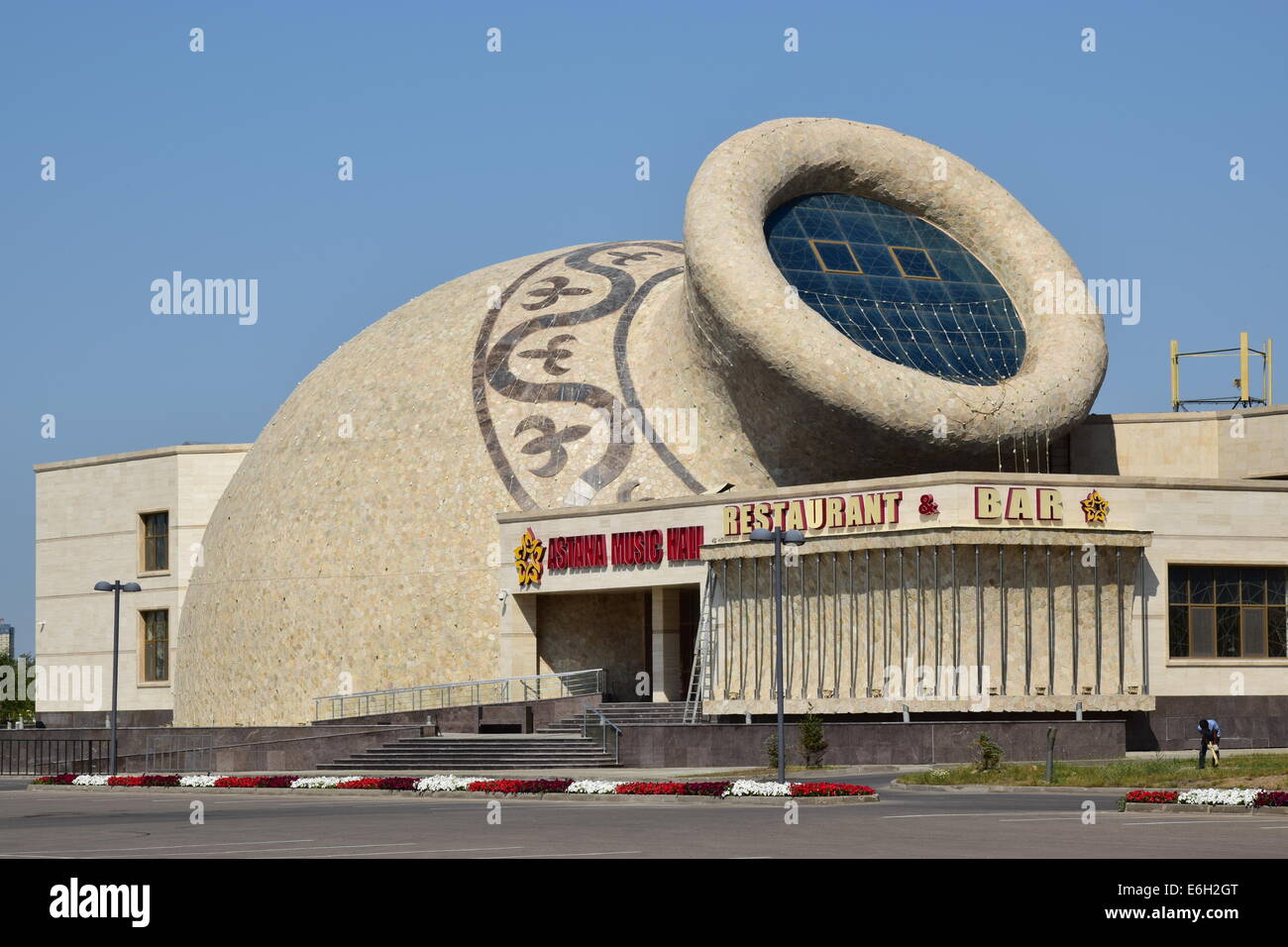 A building in the form of a pitcher lying on its side, in Astana ...