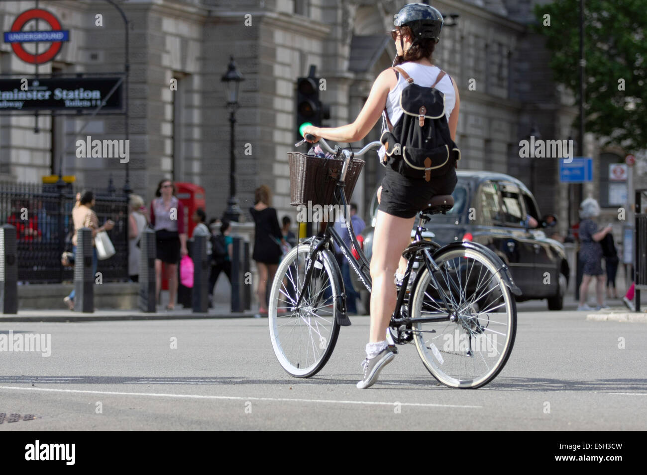 A cyclist waiting in the middle of a road to turn right Stock Photo - Alamy