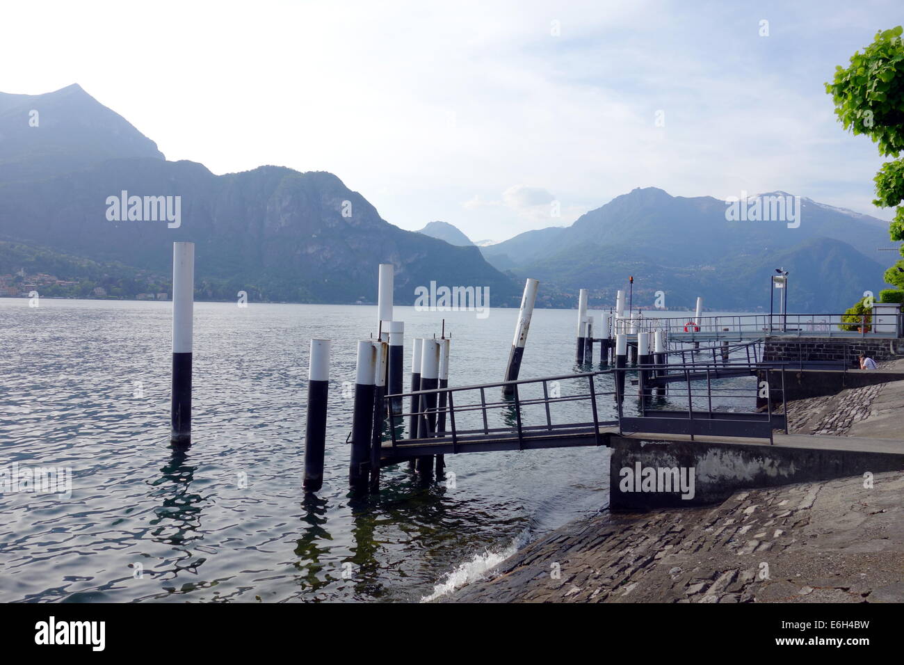 Piers and mountains in the background on the Lake Como, Italy Stock ...