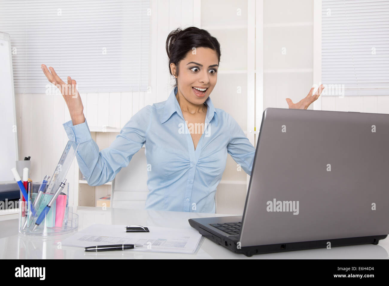Successful happy businesswoman looking happy at the screen reading a ...