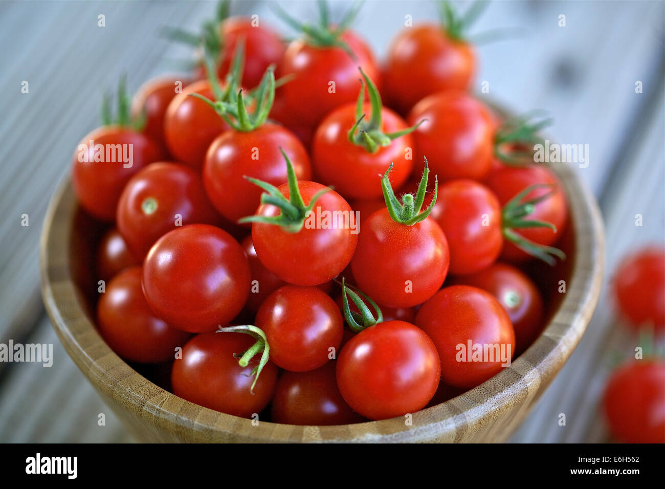 Cherry tomatoes in a wooden bowl Stock Photo - Alamy
