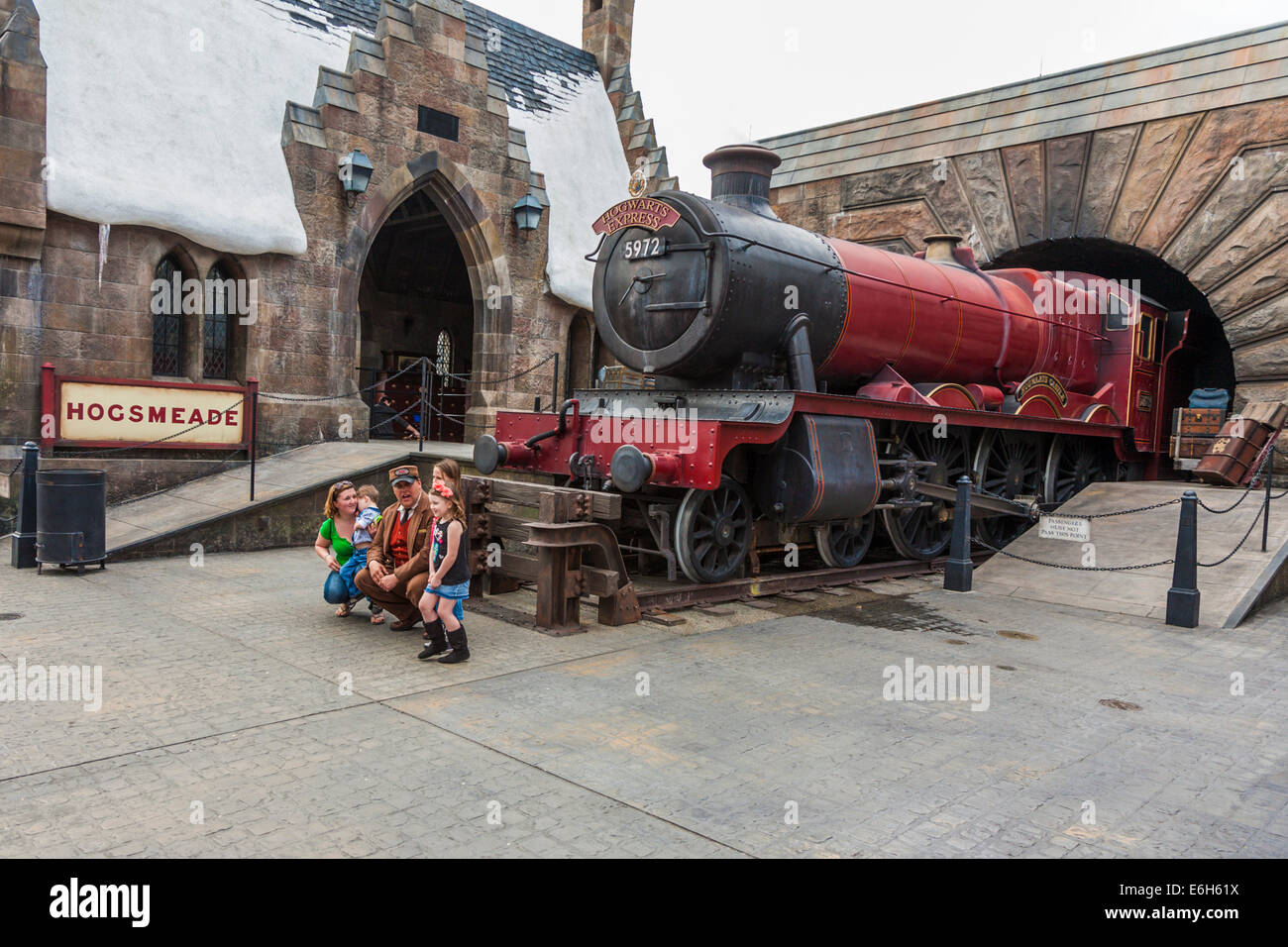 Engineer poses with family in front of the Hogsmeade Express train ...