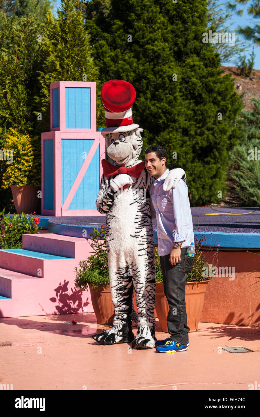 Young man posing for photo with Cat in the Hat character in Seuss ...