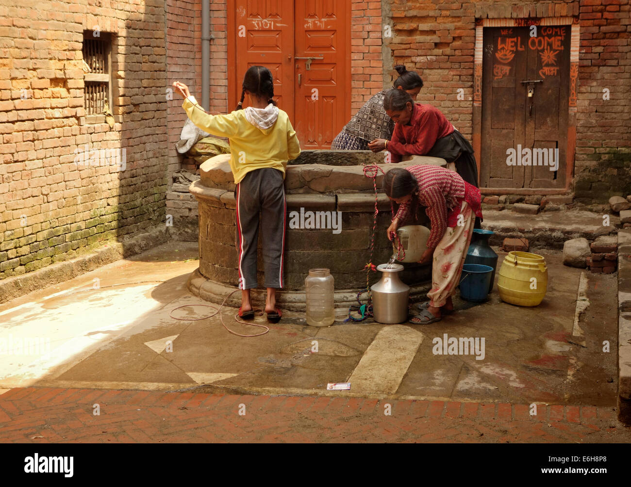 Kids gathering water at the city well Stock Photo - Alamy