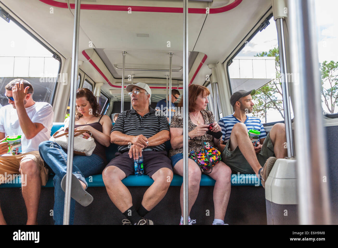 Park guests riding the Monorail between attractions in Walt Disney ...