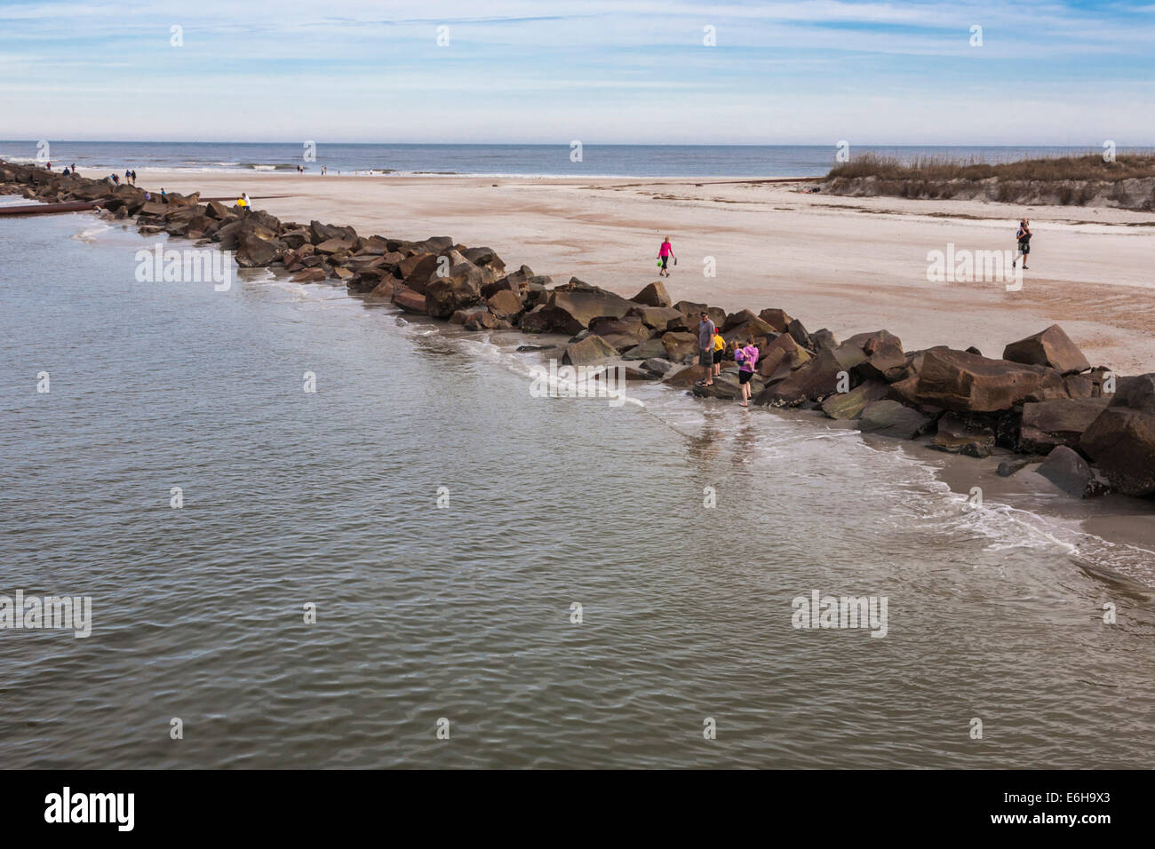 Park guests walk along the rock jetty at Fort Clinch State Park in ...