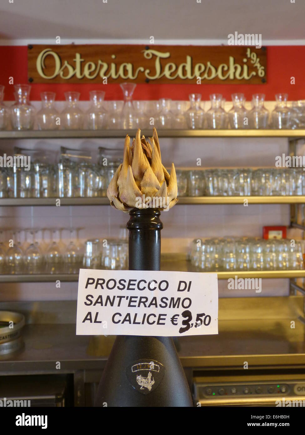 An artichoke decorates a tap dispensing prosecco in a beach bar on the ...