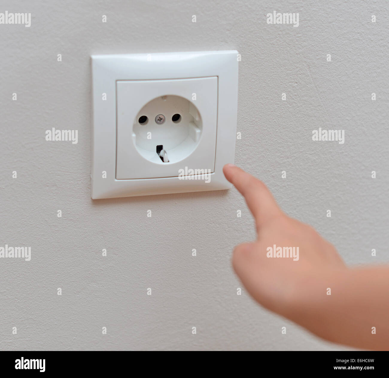 Child sticks his fingers in the socket. Dangerous situation at home ...