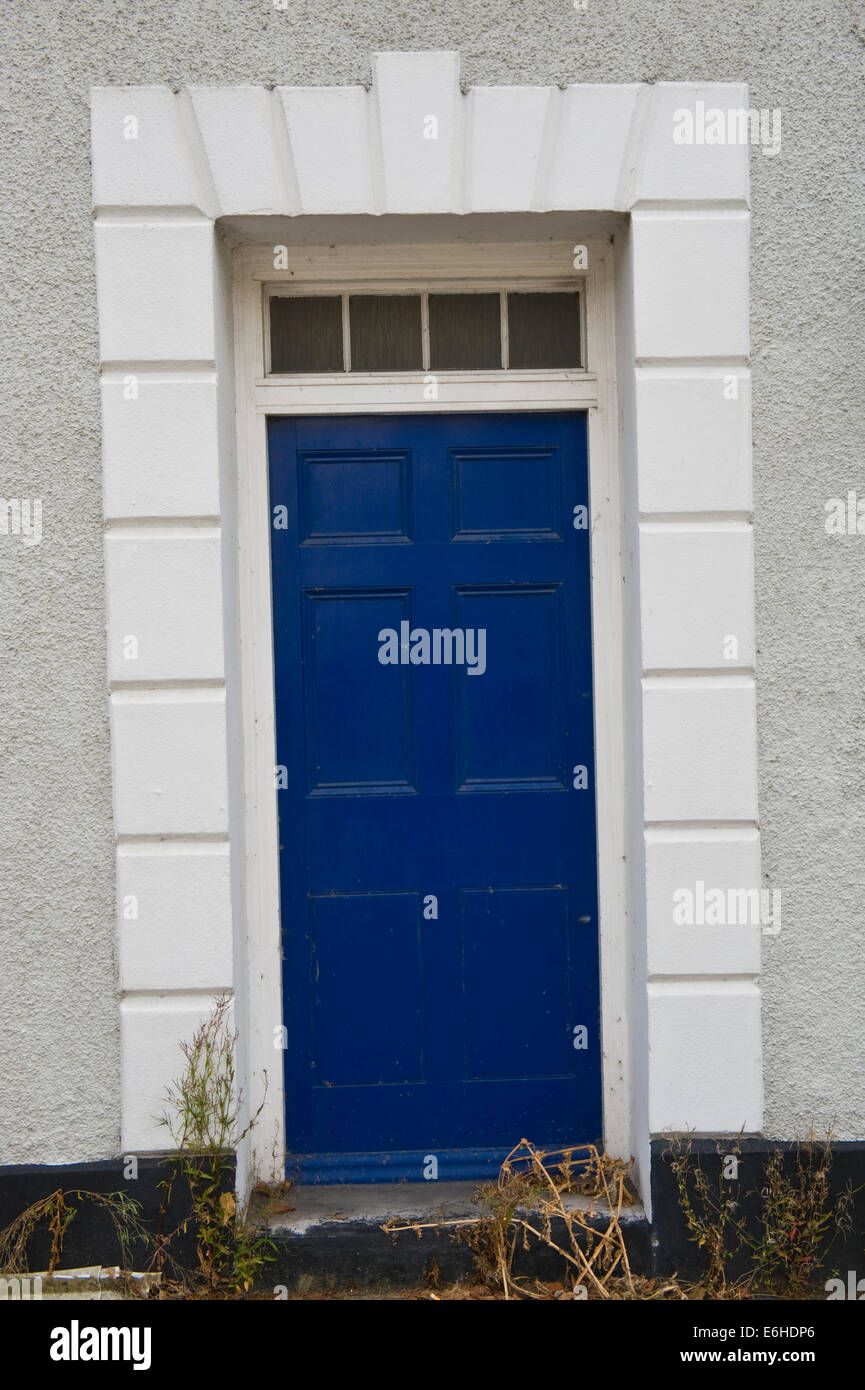 Blue handleless wooden front door of period terraced house in Brecon ...