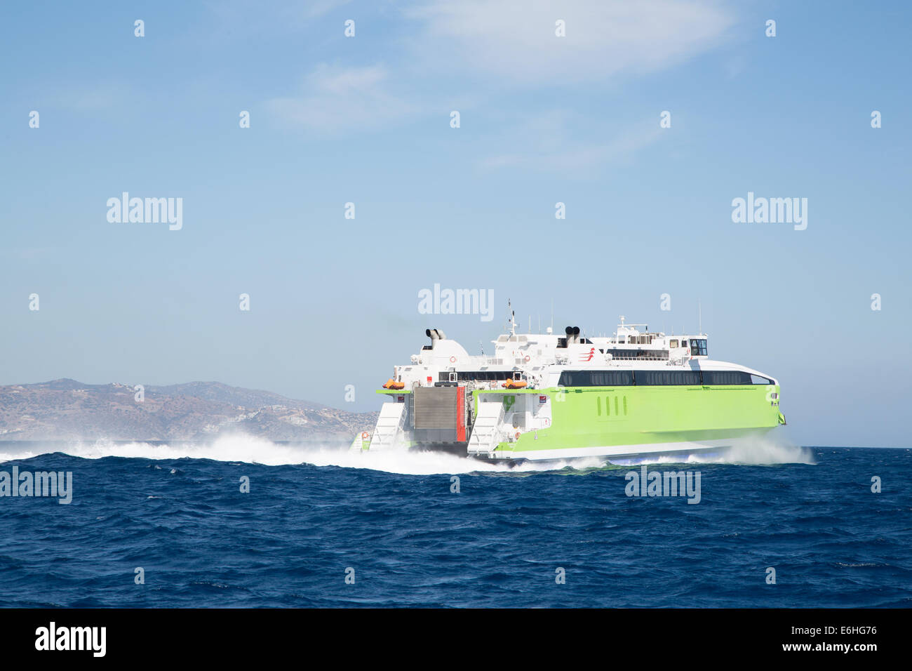 Green ferry speed boat on the greek islands with blue water background ...