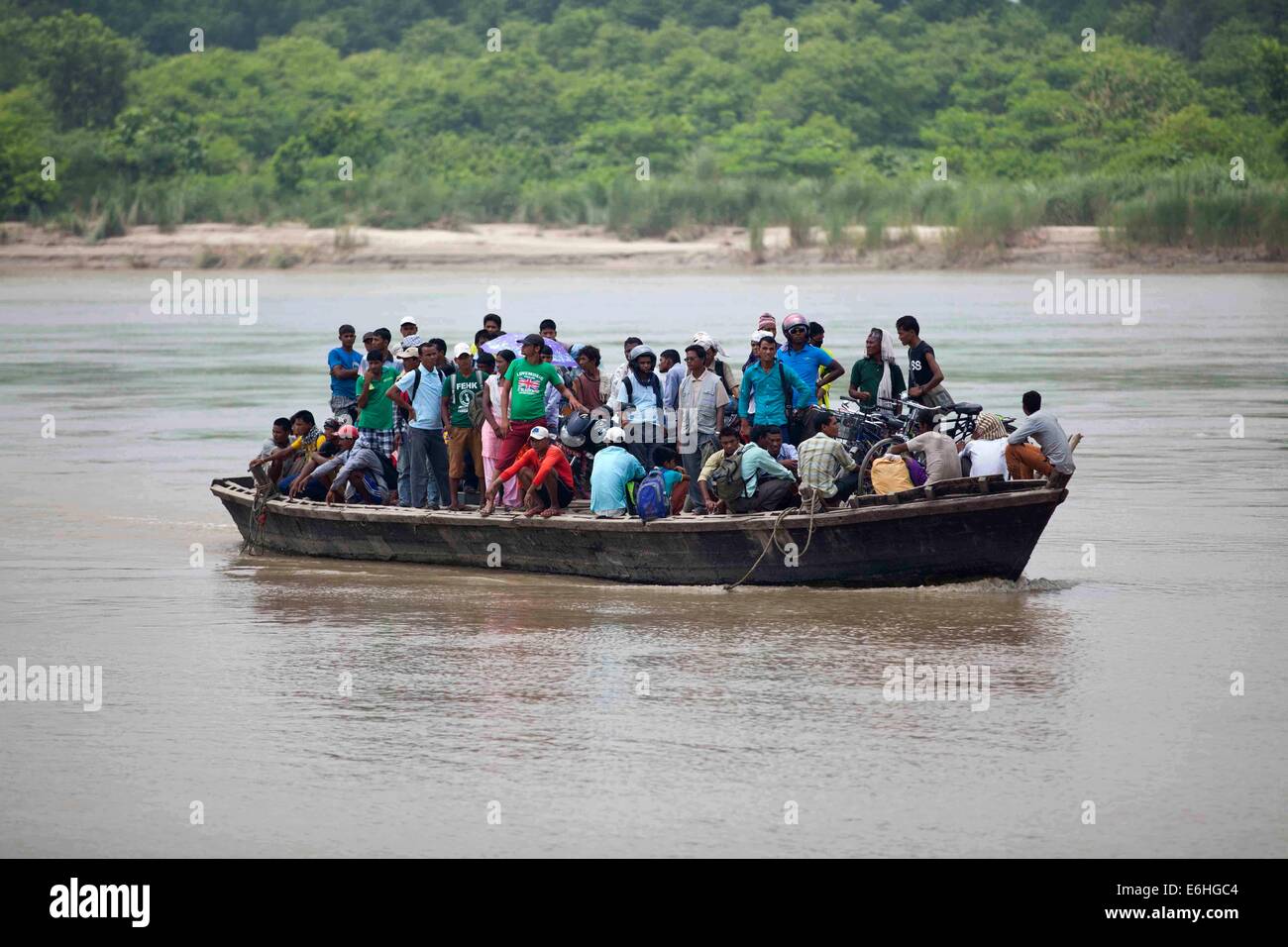 Bardiya, Nepal. 24th Aug, 2014. Flood-affected people take a boat to ...