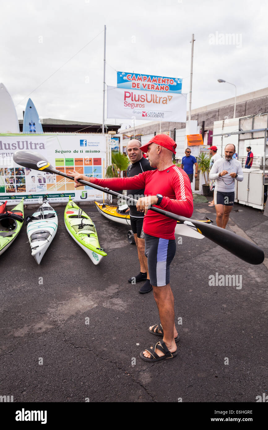 Athlete with a paddle discussing technique with a colleague during ...