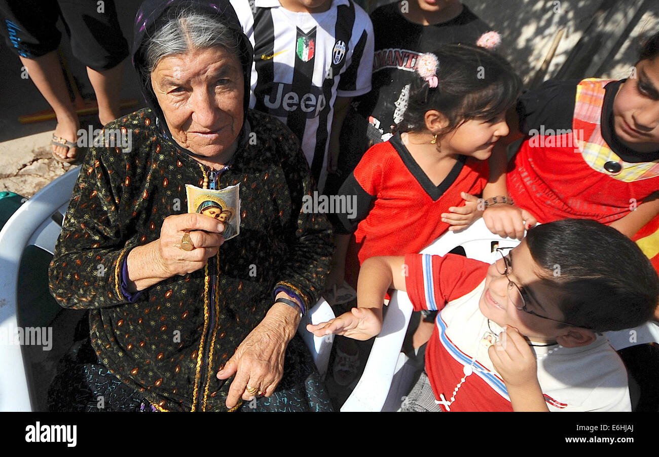 Levo, Iraq. 24th Aug, 2014. A Christian refugee kisses an icon of the ...