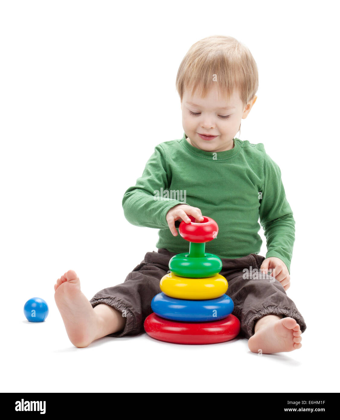 Small baby with a toy pyramid. Isolated on white background Stock Photo ...